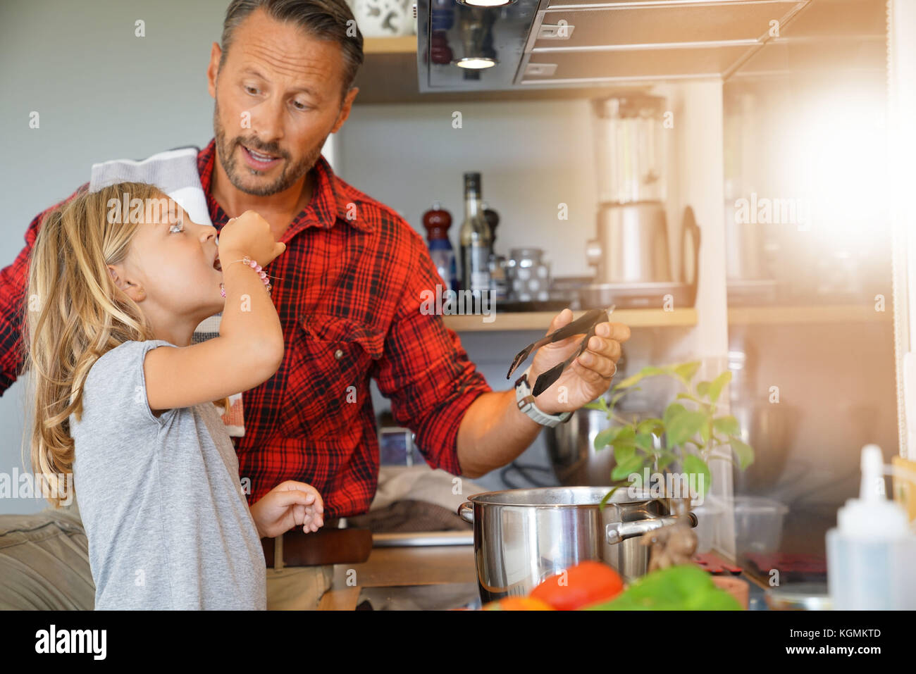 Daddy with daughter cooking together in home kitchen Stock Photo - Alamy