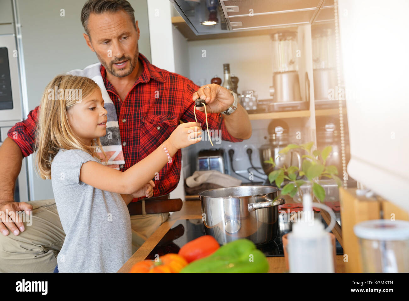 Daddy with daughter cooking together in home kitchen Stock Photo - Alamy
