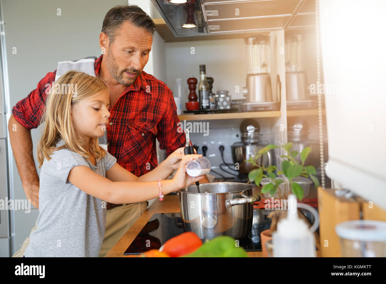 Daddy with daughter cooking together in home kitchen Stock Photo - Alamy