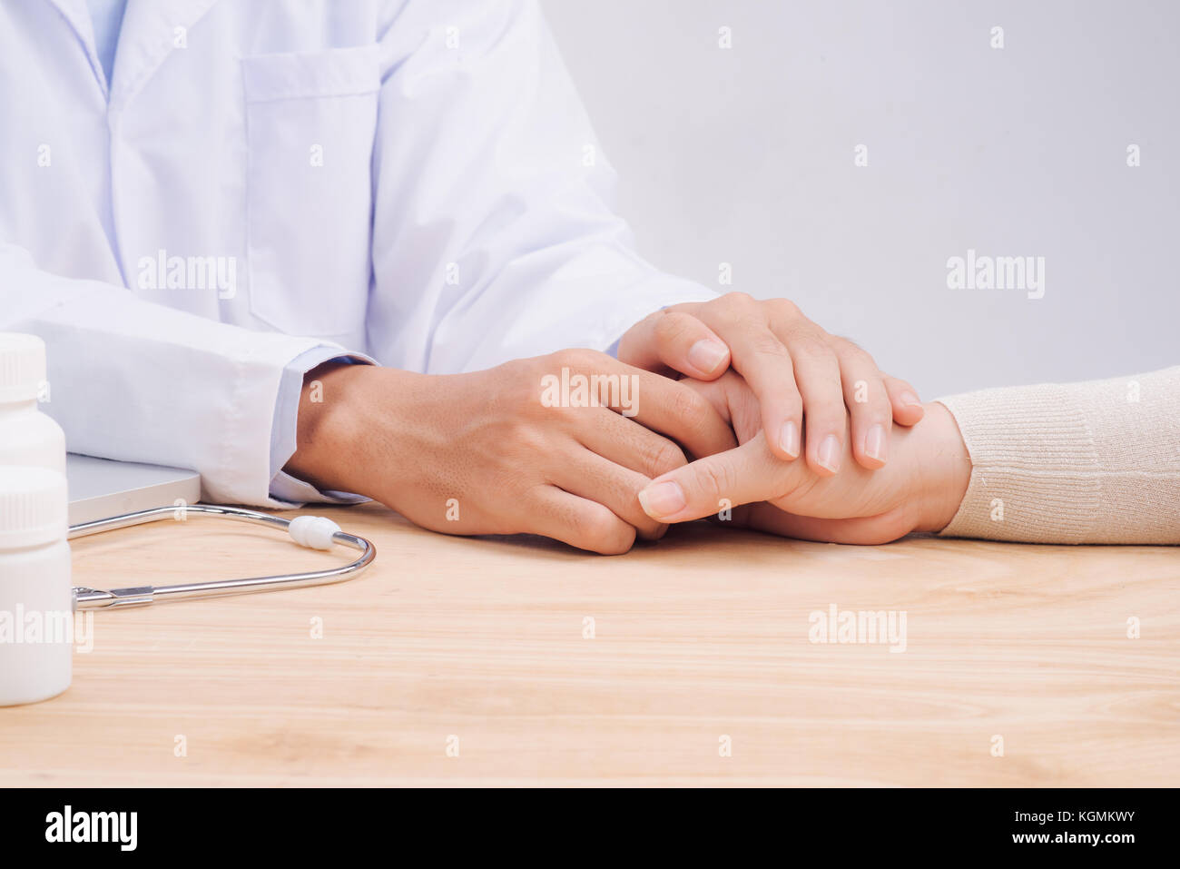 Hand of doctor reassuring her female patient Stock Photo - Alamy