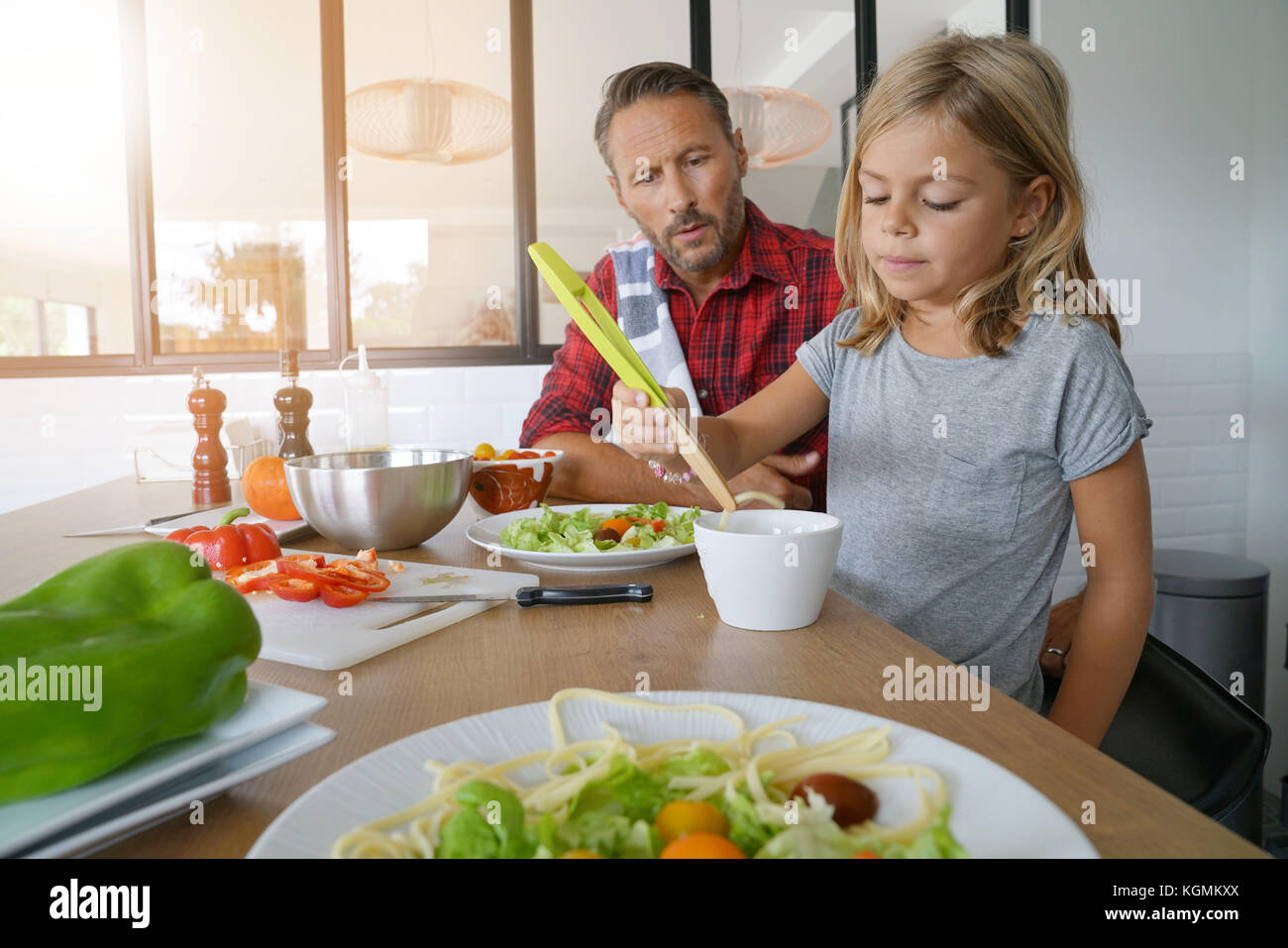 Father and daughter cooking pasta dish together Stock Photo - Alamy