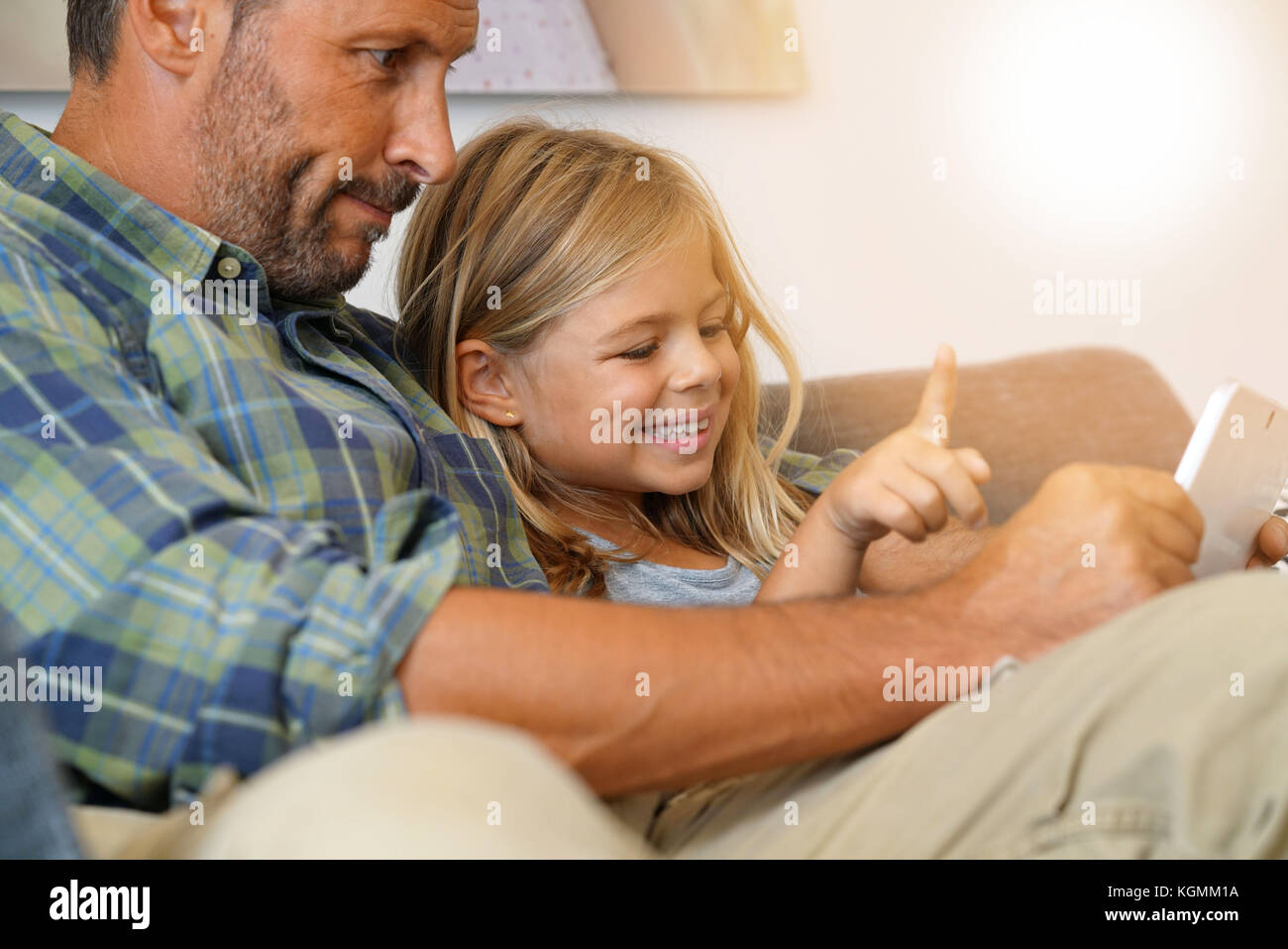 Daddy with little girl connected on digital tablet Stock Photo - Alamy