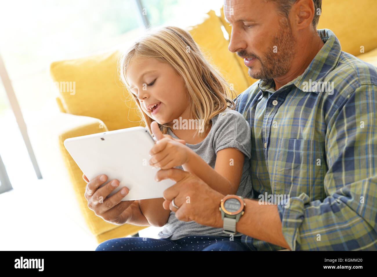 Daddy with little girl connected on digital tablet Stock Photo - Alamy