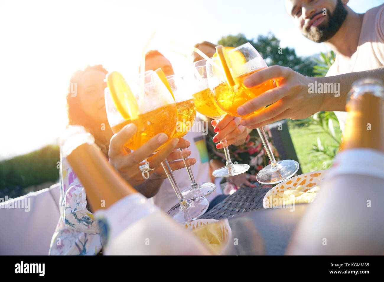 Summer party, group of friends cheering up with drinks Stock Photo - Alamy