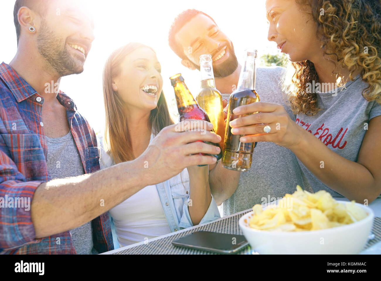 Group of friends cheering with beers Stock Photo - Alamy