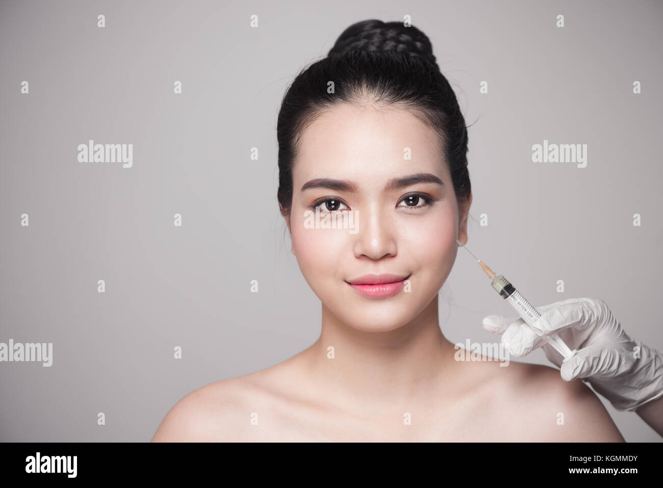 Beautiful asian woman gets beauty facial injections. Face aging ...