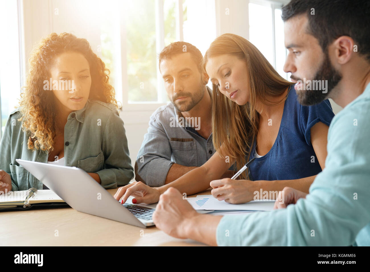 Startup team meeting together around table Stock Photo - Alamy