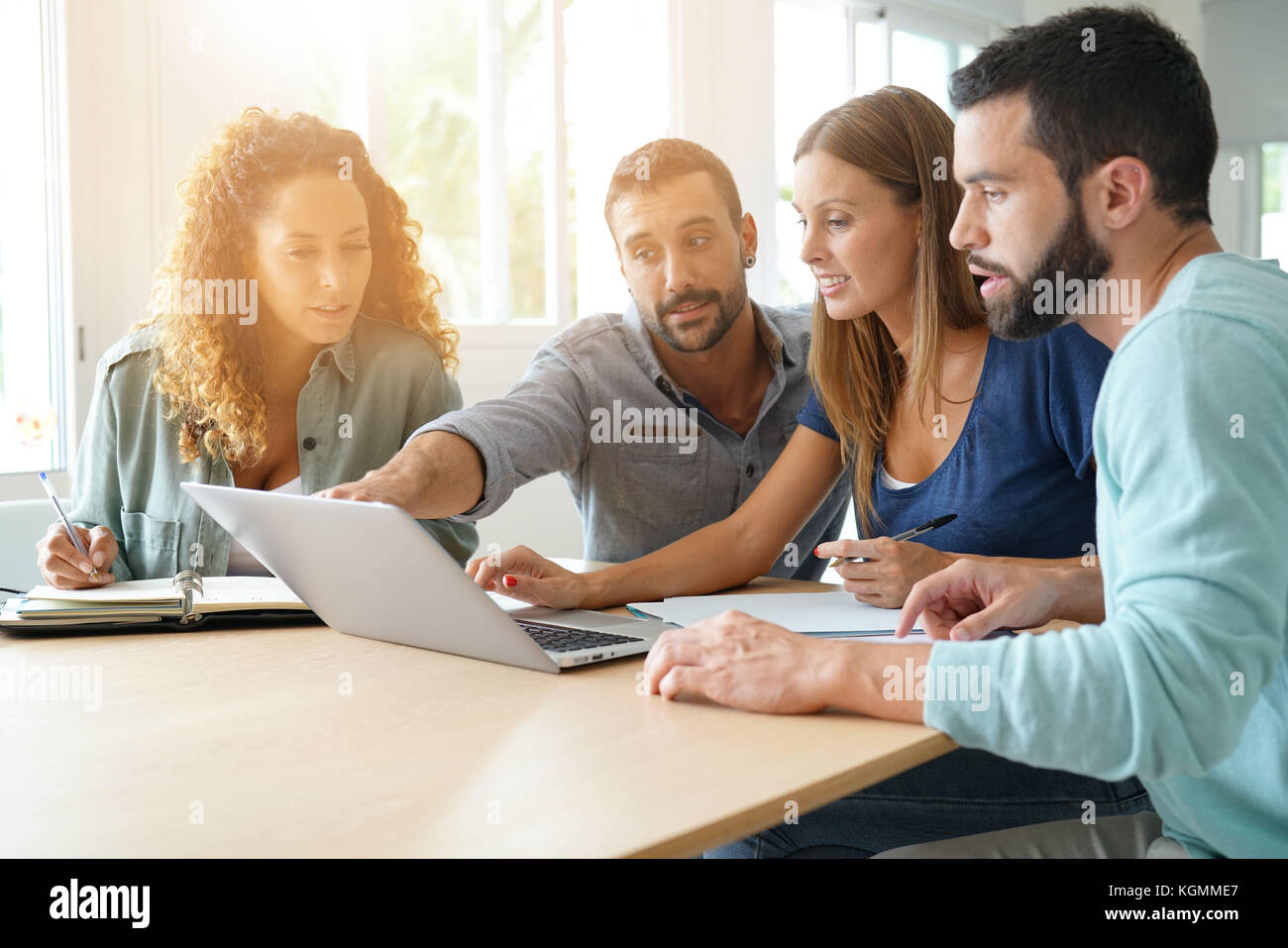 Startup team meeting together around table Stock Photo - Alamy