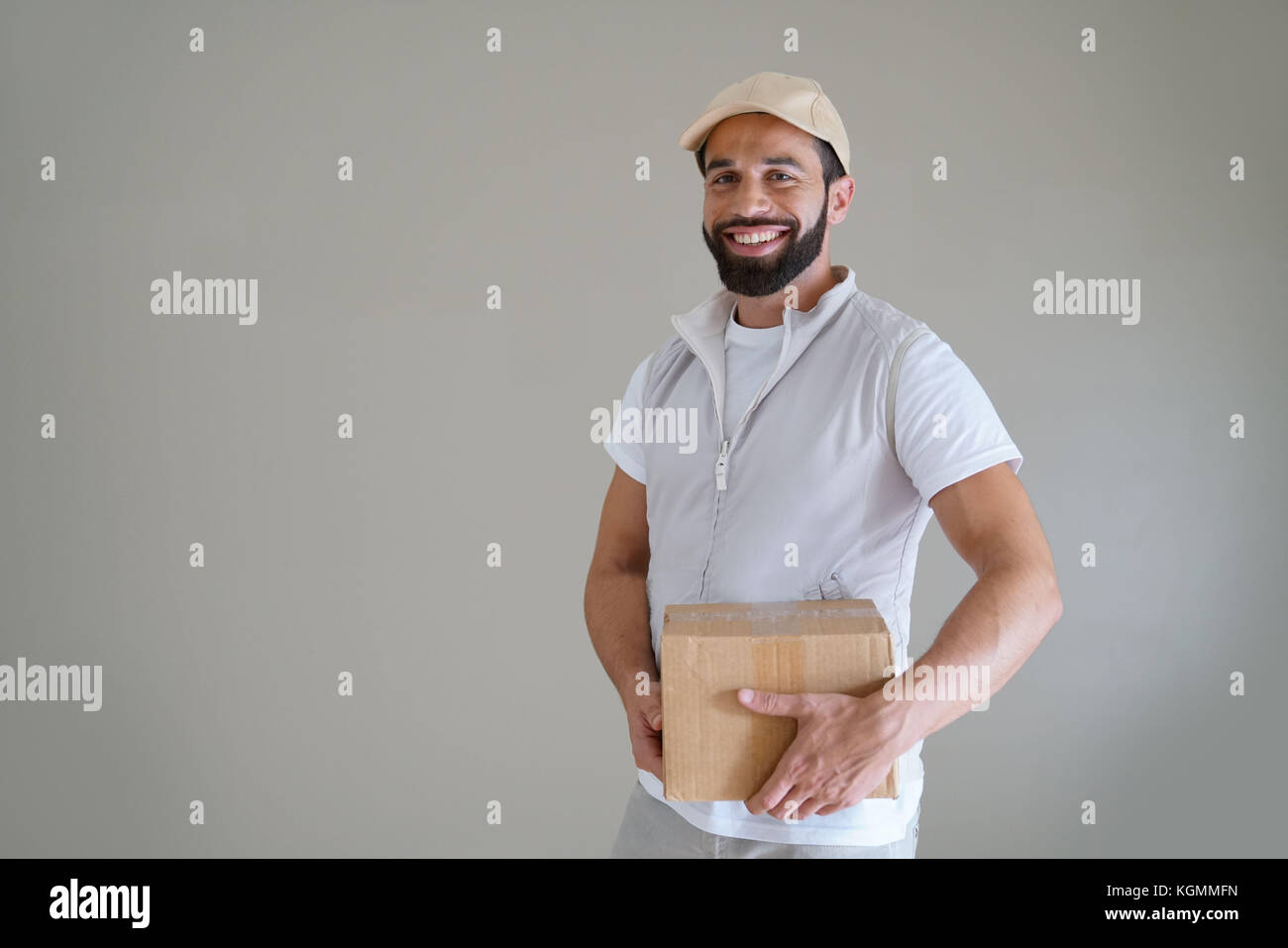Smiling delivery man, isolated Stock Photo - Alamy