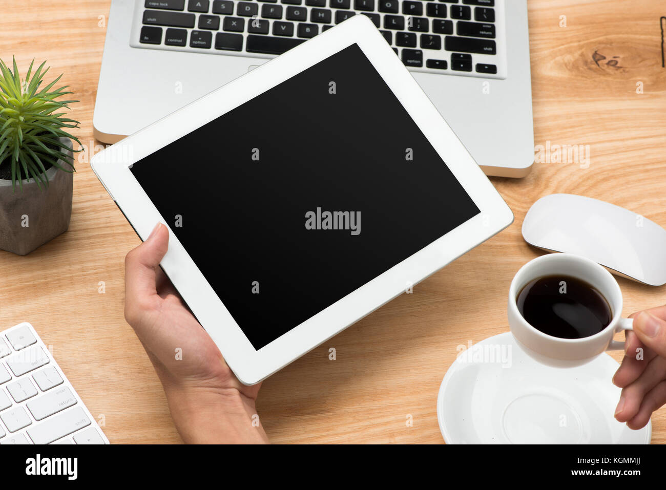 Hand using digital tablet with blank screen on desk work table Stock ...