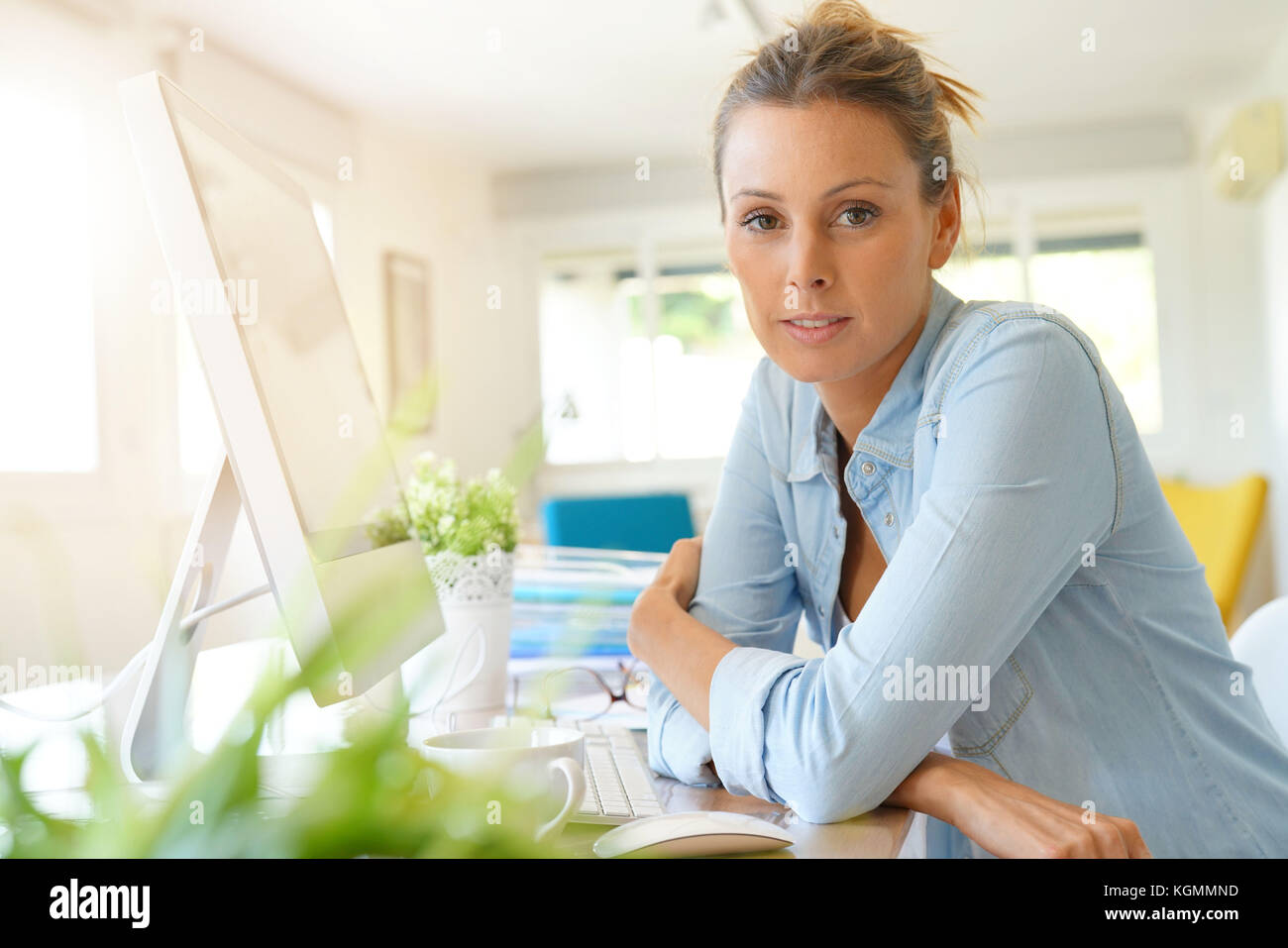 Beautiful young woman in office working on desktop computer Stock Photo ...