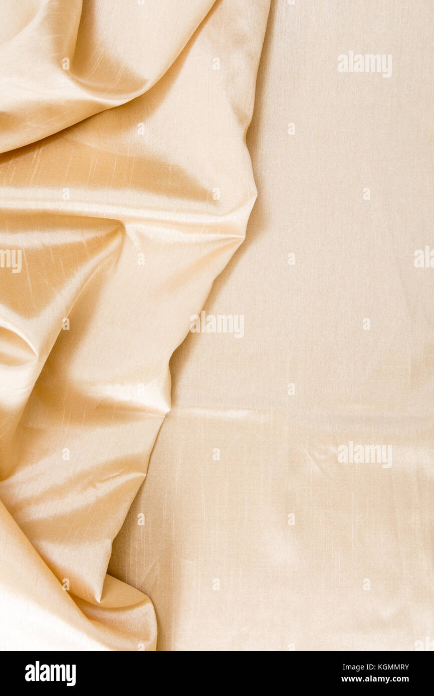 Golden wavy fabric texture / background Stock Photo - Alamy