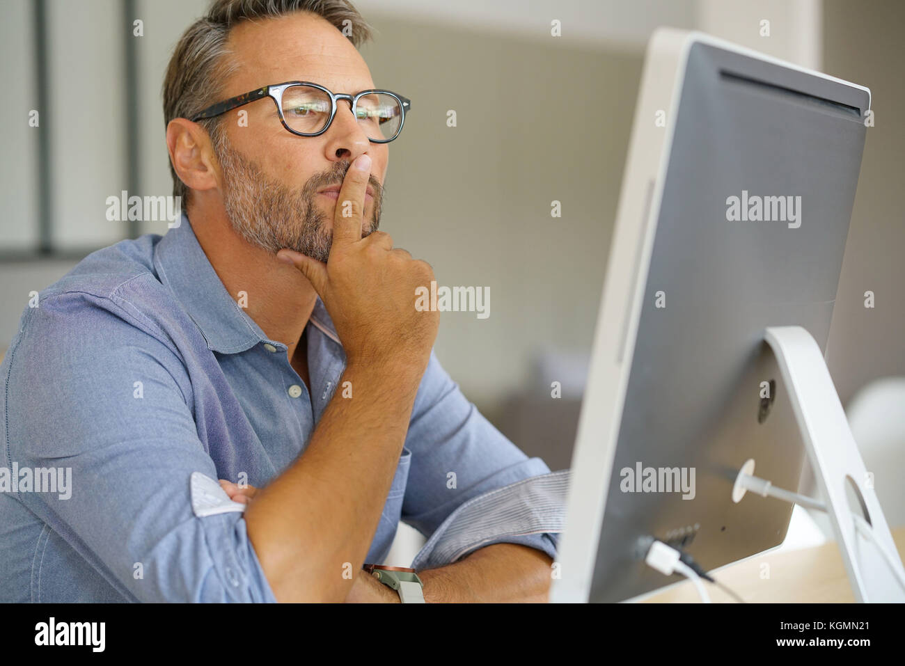 Businessman working on desktop computer Stock Photo - Alamy