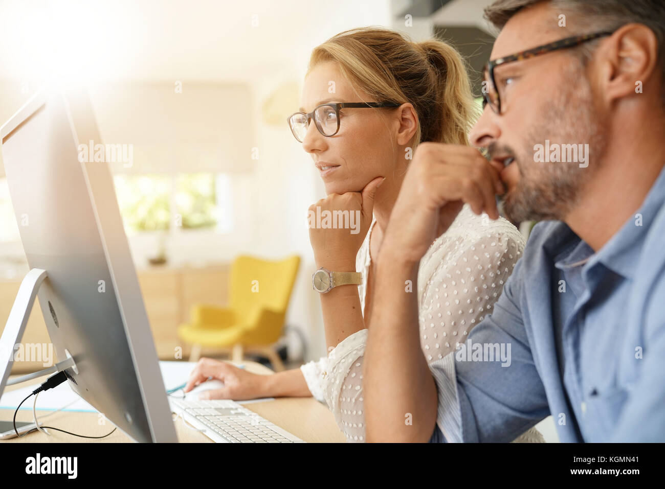 Business people working together on desktop computer Stock Photo - Alamy