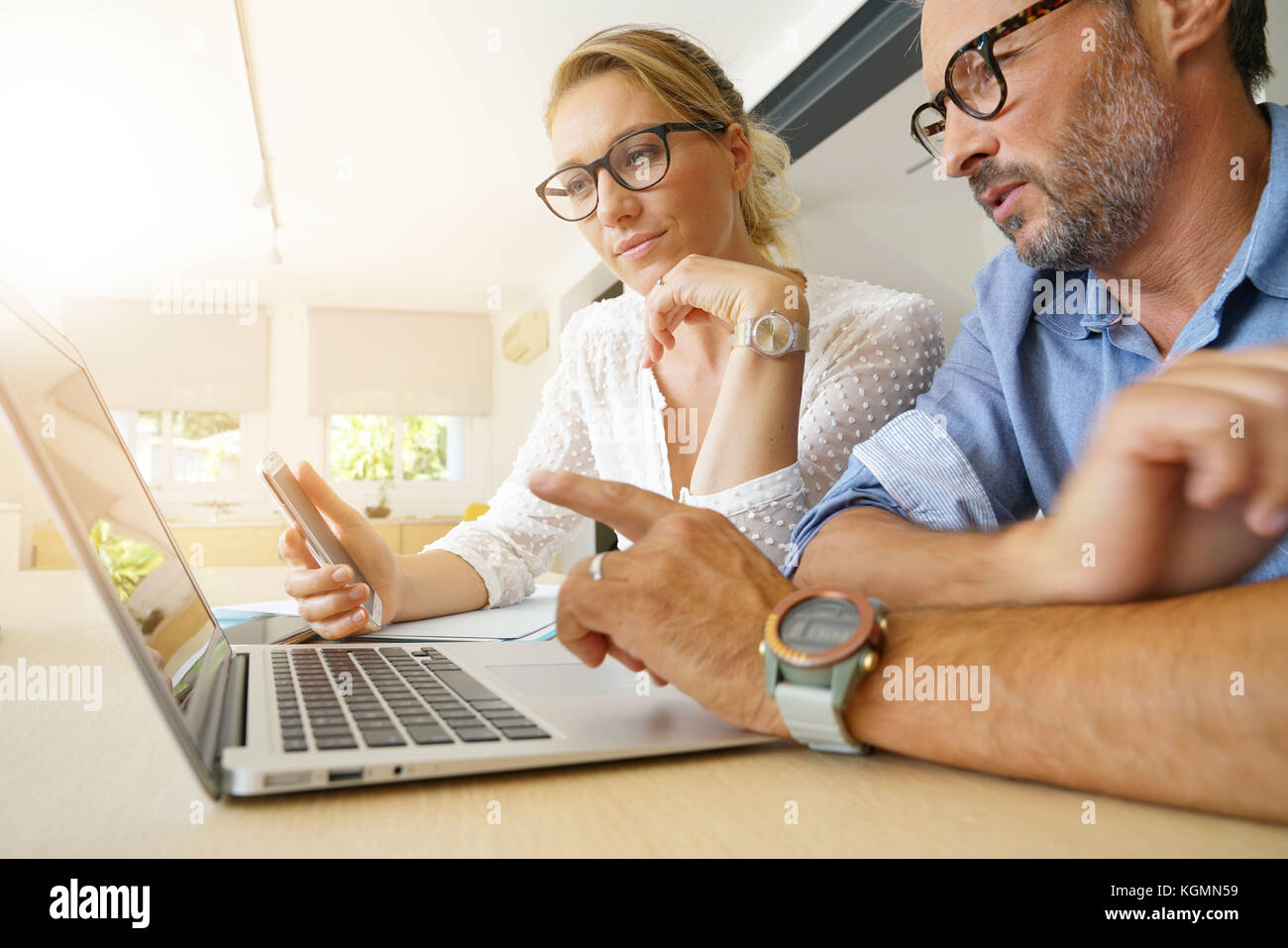 Business team working on project using laptop Stock Photo - Alamy