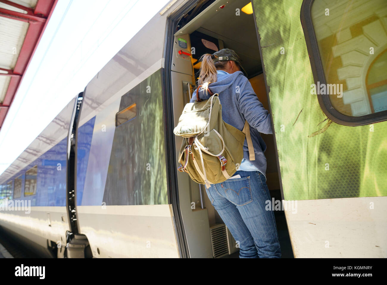 Traveler getting on a train Stock Photo - Alamy