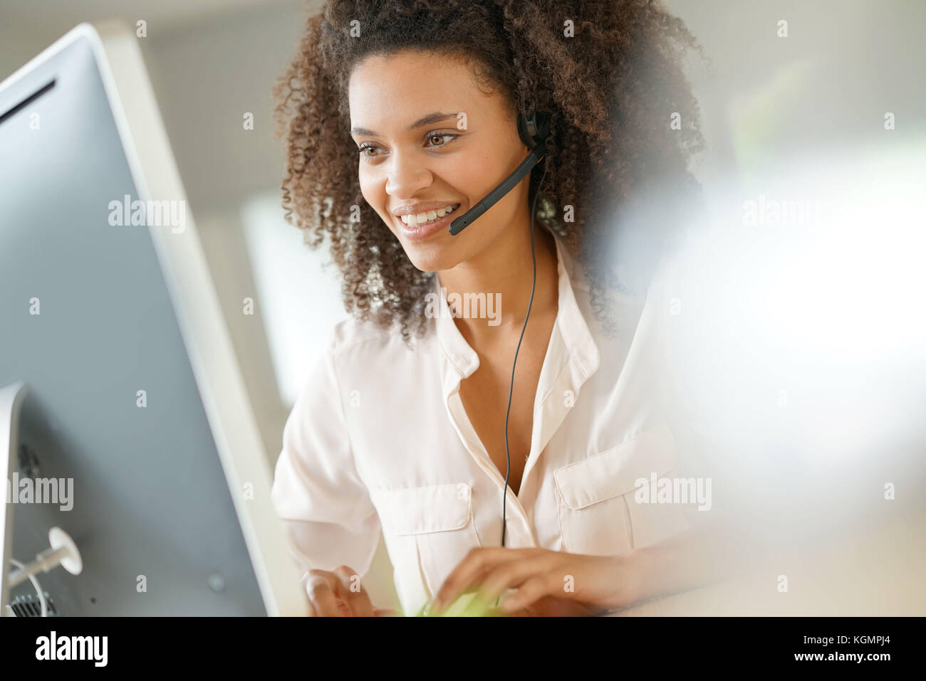 Portrait of customer service assistant talking on phone Stock Photo - Alamy