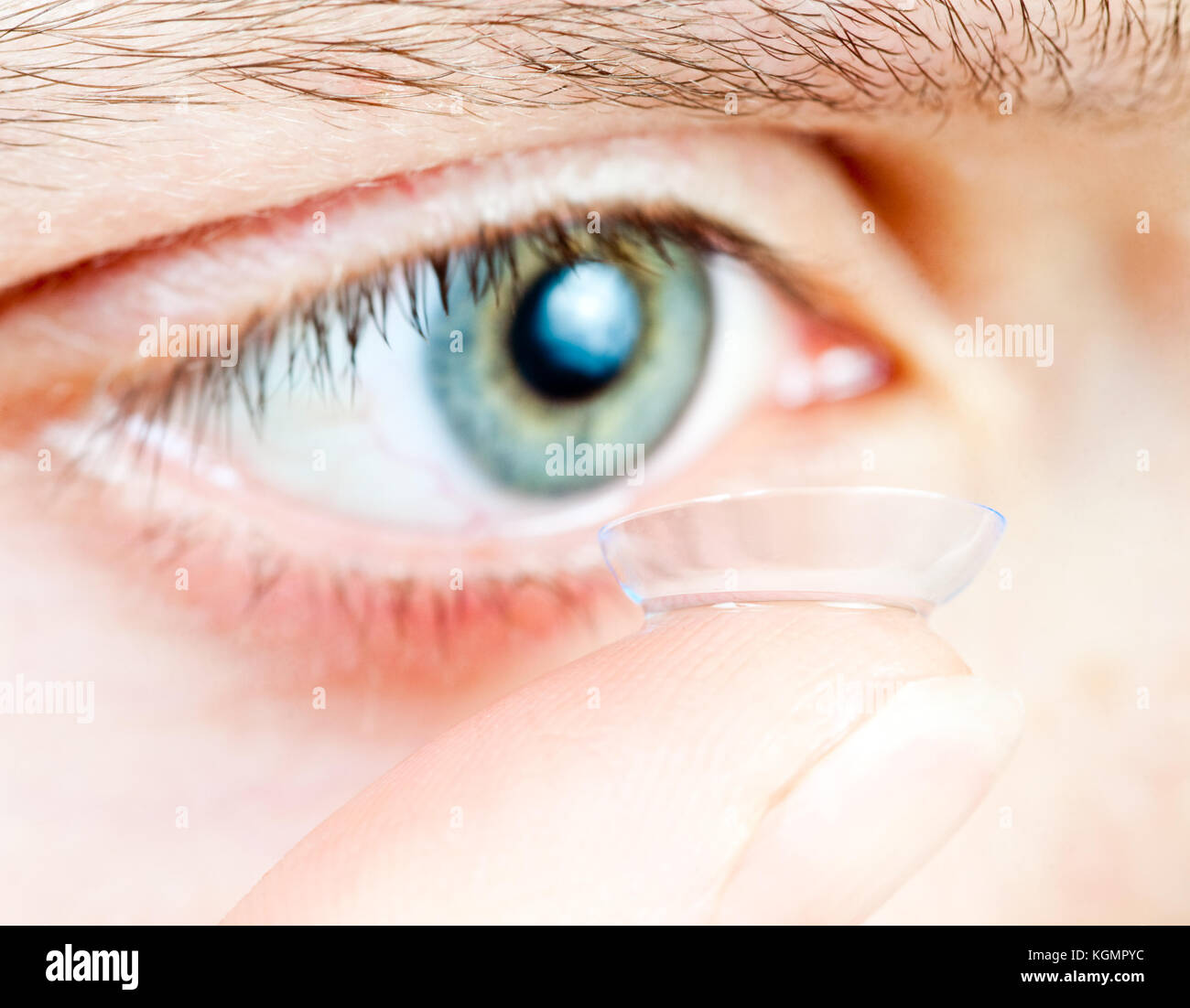 Young woman Inserting a contact lens closeup, shallow focus Stock Photo ...