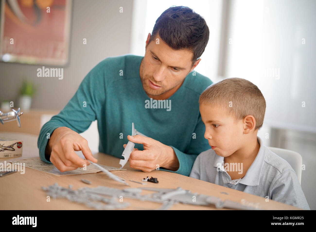 Father and son building up model together Stock Photo - Alamy