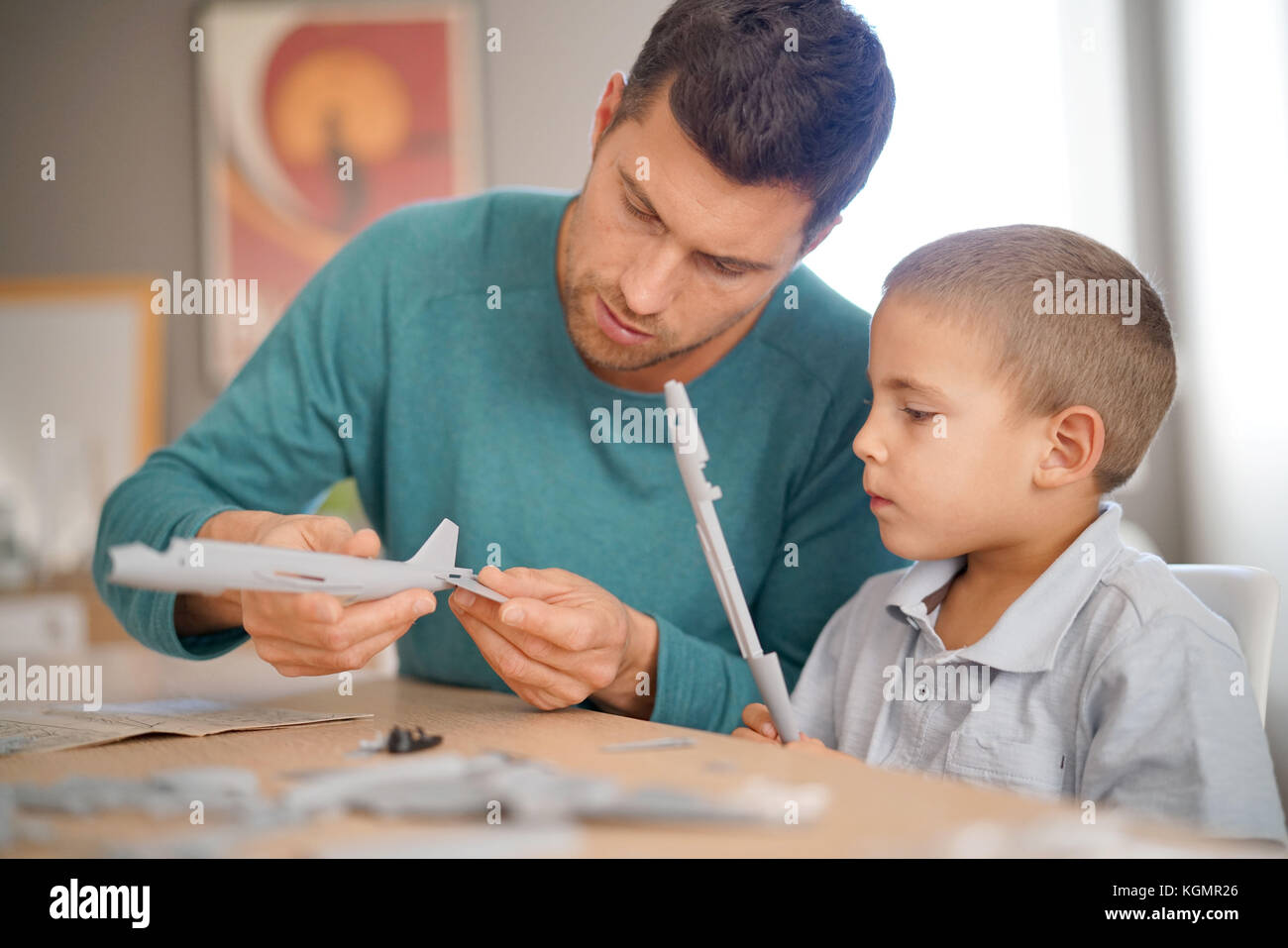 Father and son building up model together Stock Photo - Alamy