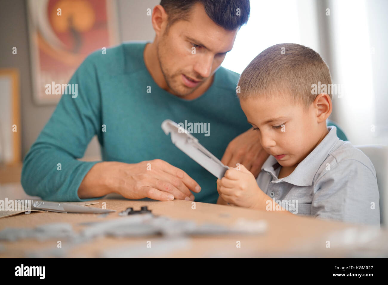 Father and son building up model together Stock Photo - Alamy