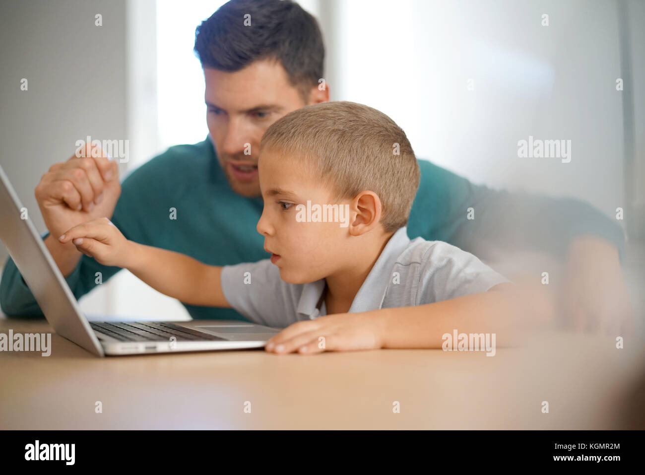 Daddy with kid using laptop computer for e-learning Stock Photo - Alamy