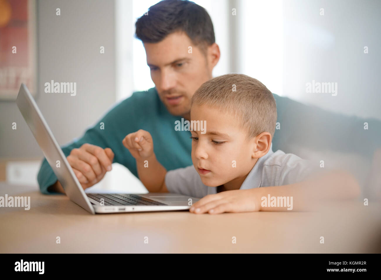 Daddy with kid using laptop computer for e-learning Stock Photo - Alamy