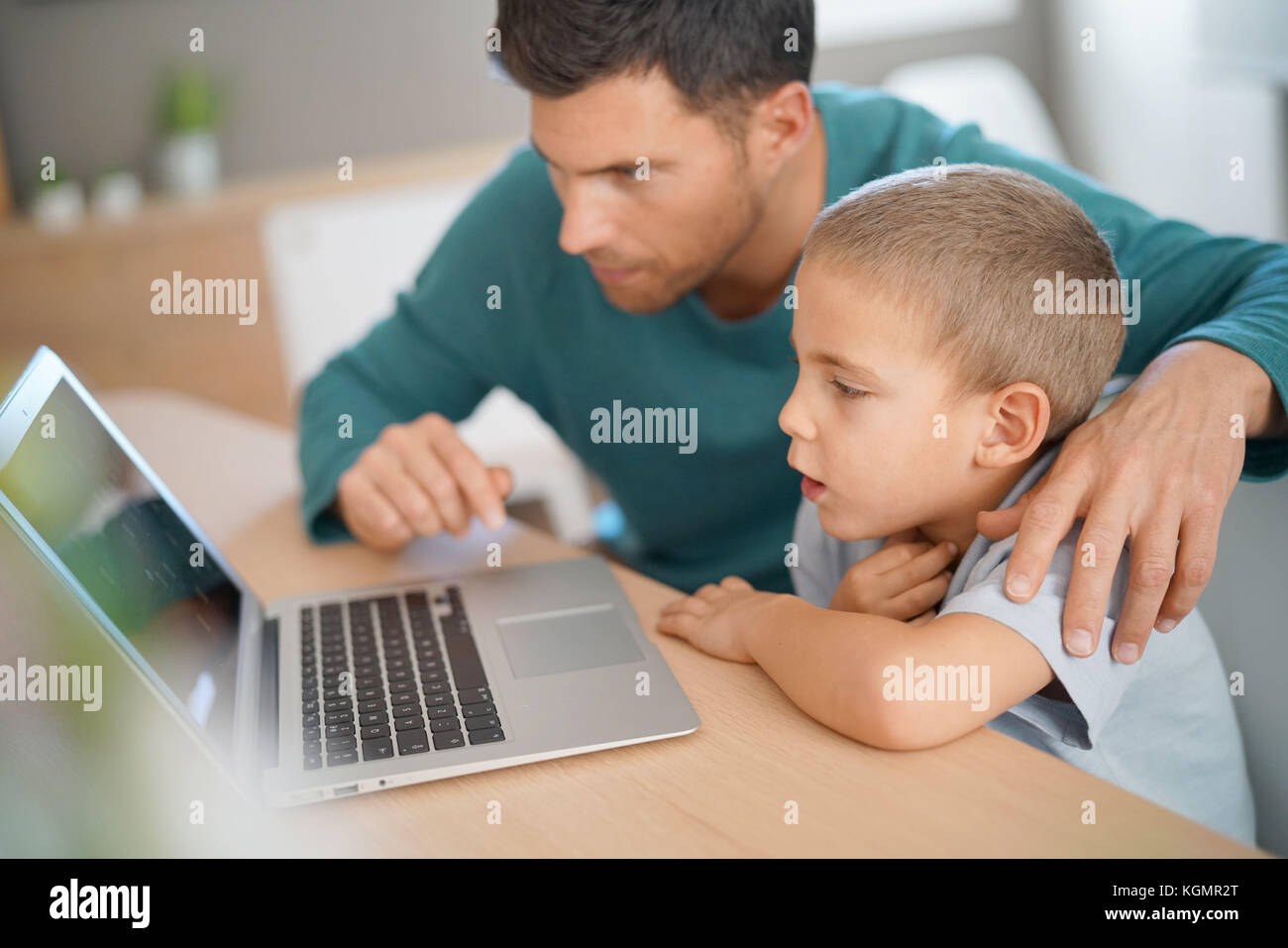 Daddy with kid using laptop computer for e-learning Stock Photo - Alamy