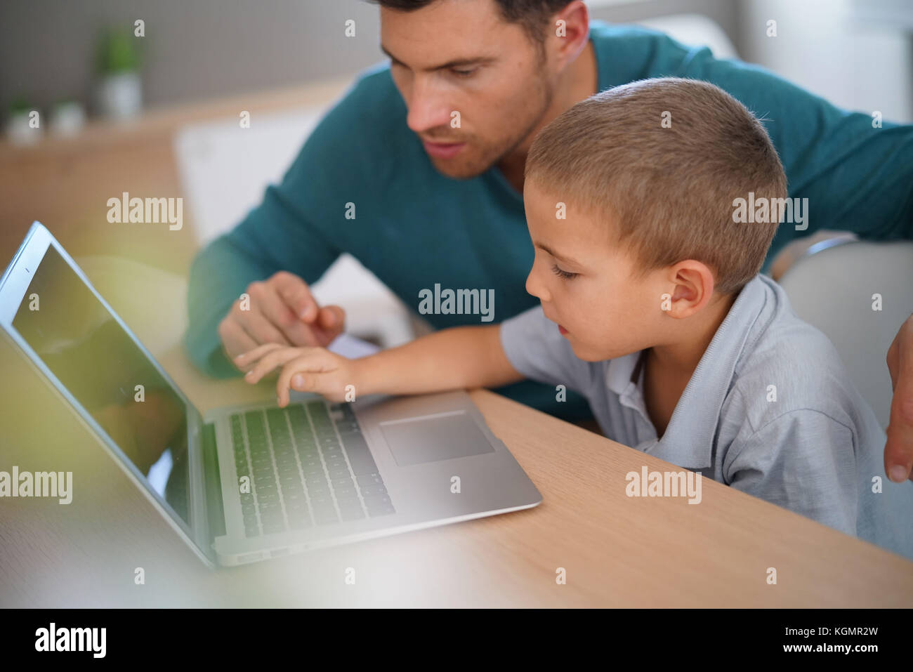 Daddy with kid using laptop computer for e-learning Stock Photo - Alamy