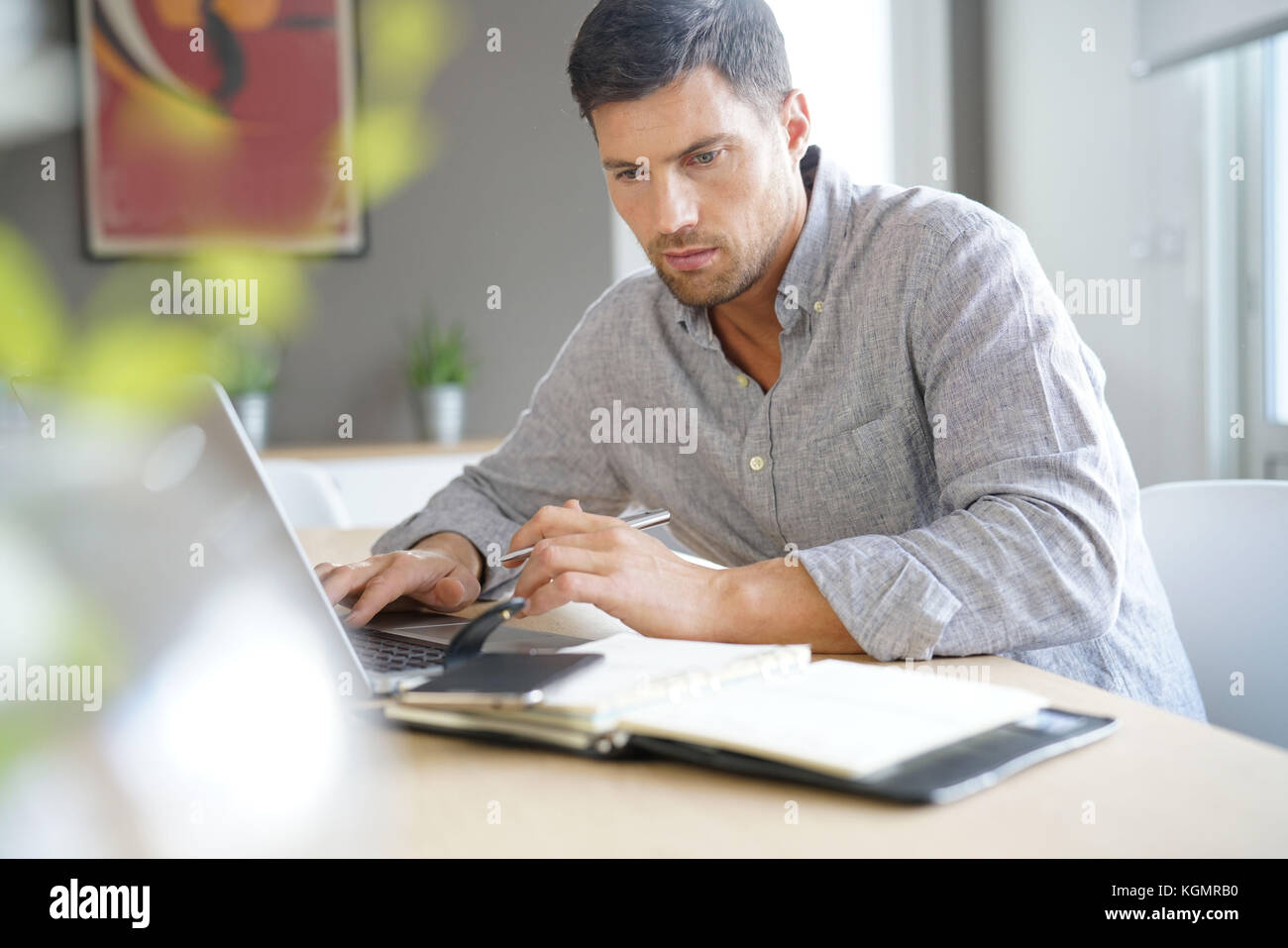 Middle-aged man working from home on laptop computer Stock Photo - Alamy