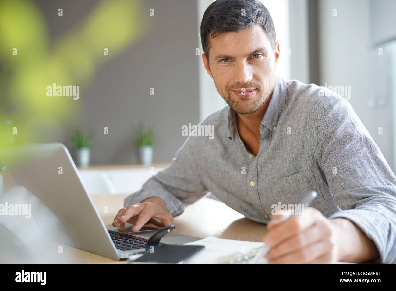 Middle-aged man working from home on laptop computer Stock Photo - Alamy