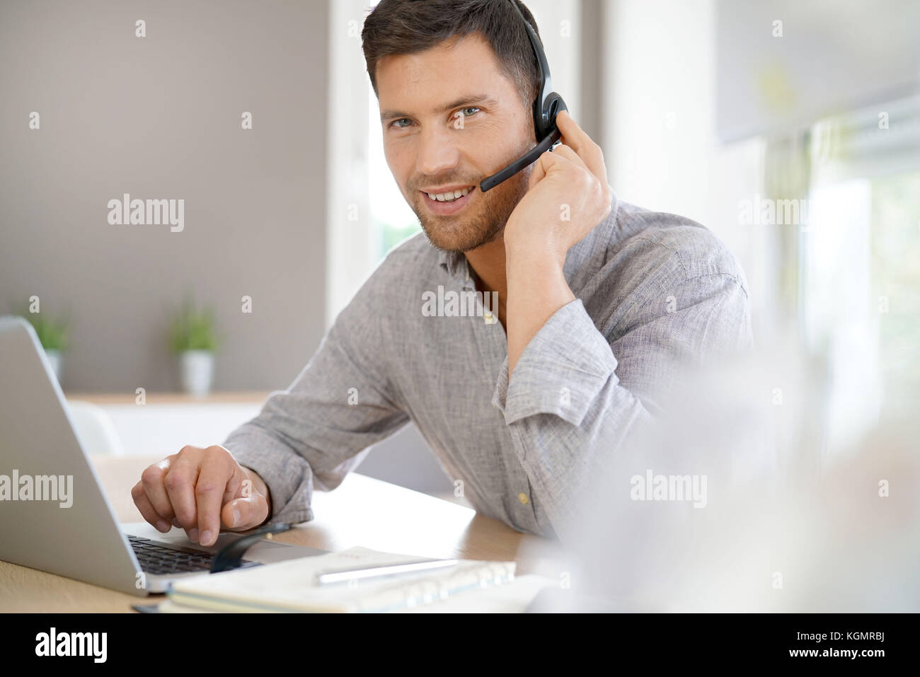 Sales representative working from home on laptop computer Stock Photo ...