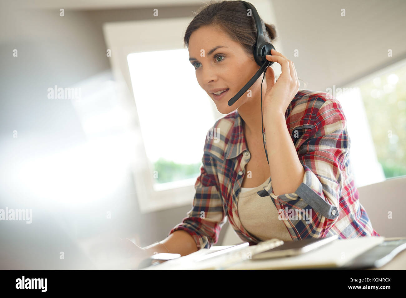 Customer service representative working from home on laptop Stock Photo ...