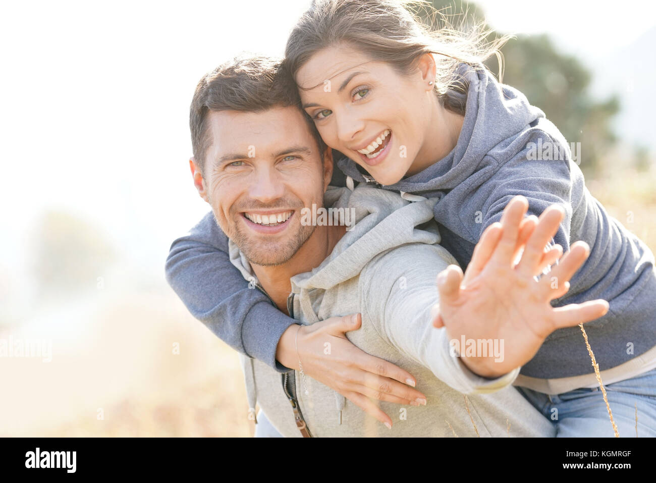 Man giving piggyback ride to girlfriend in countryside Stock Photo - Alamy