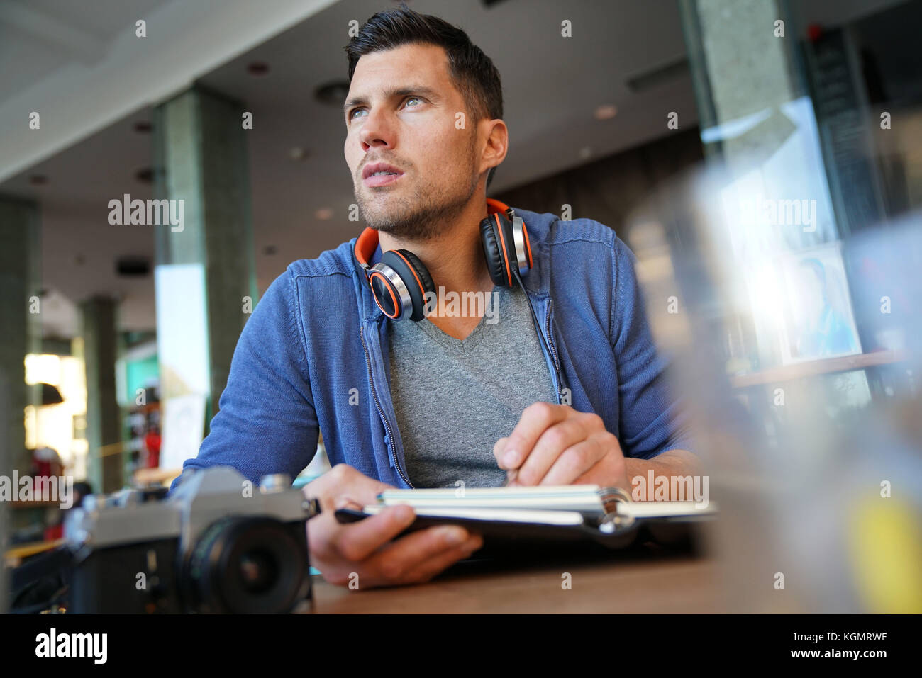 Man sitting in restaurant writing notes on agenda Stock Photo - Alamy