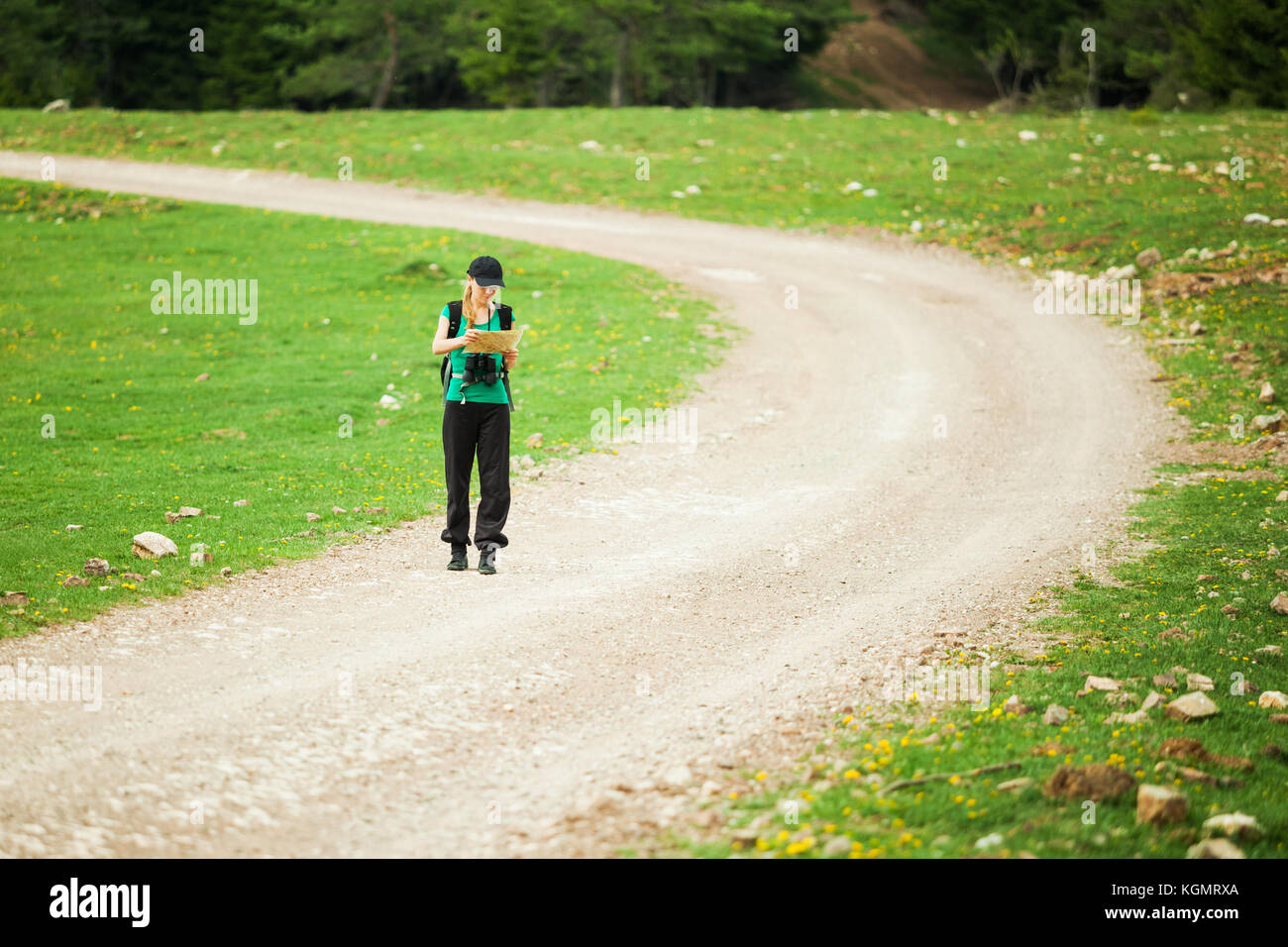 Hiker looking on map Stock Photo - Alamy