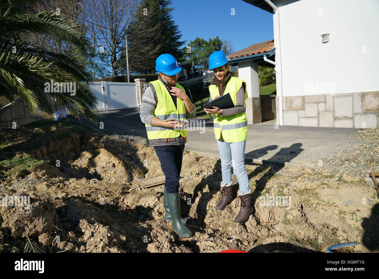 Construction site professional looking at digging in work Stock Photo ...