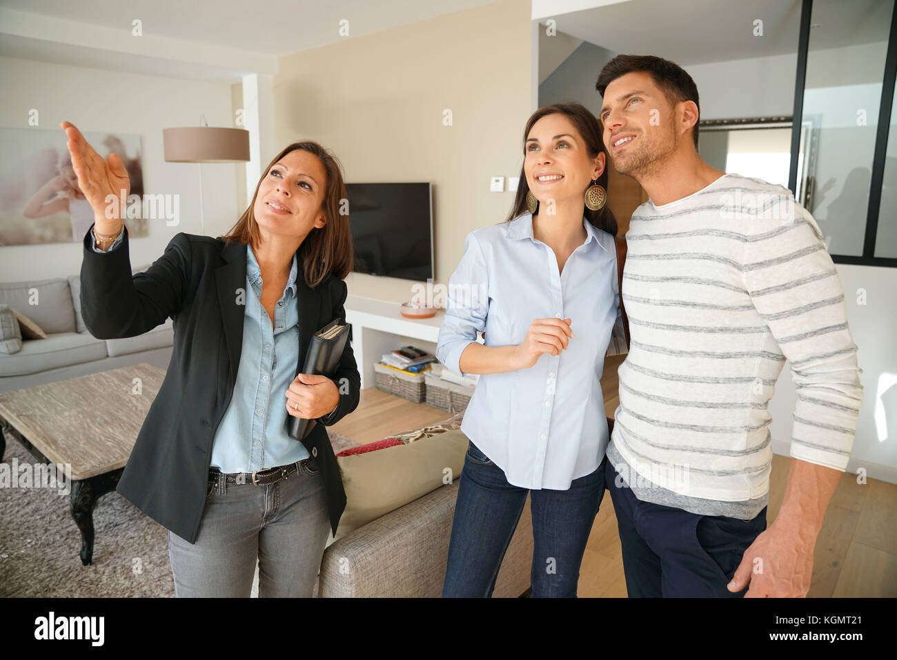 Couple with real-estate agent visiting house for sale Stock Photo - Alamy