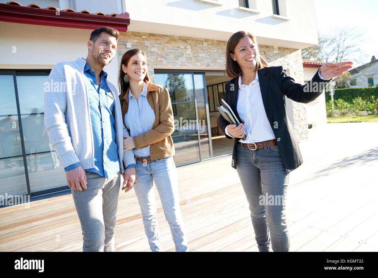 Couple with real-estate agent visiting house for sale Stock Photo - Alamy