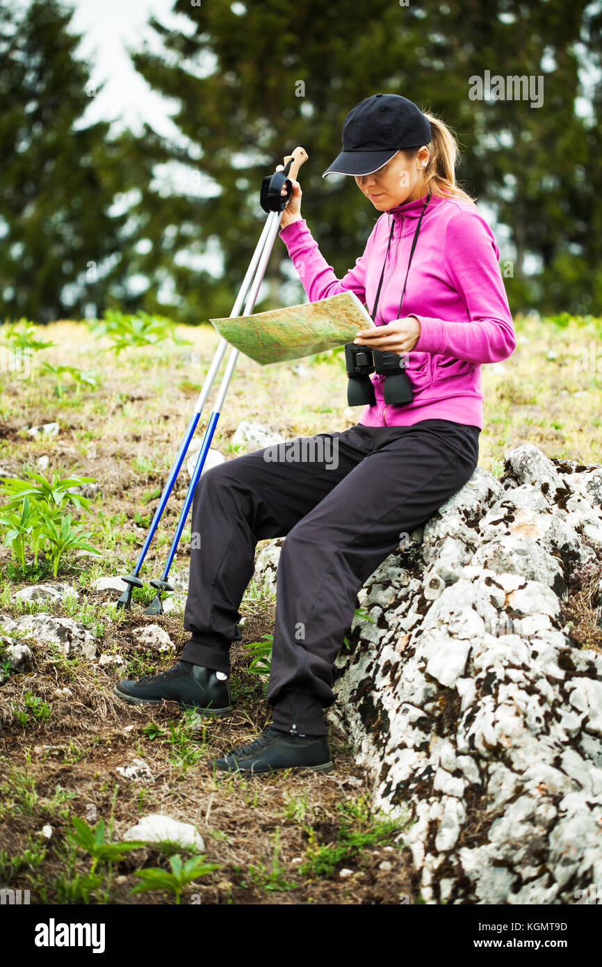 Hiker looking on map Stock Photo - Alamy