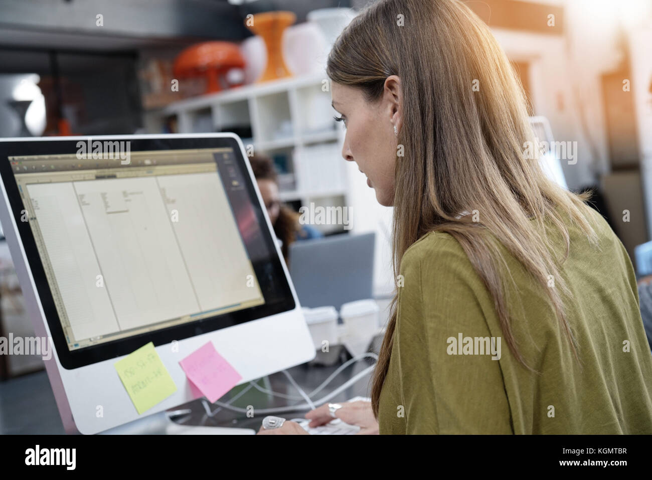 Woman in office working on desktop computer Stock Photo - Alamy