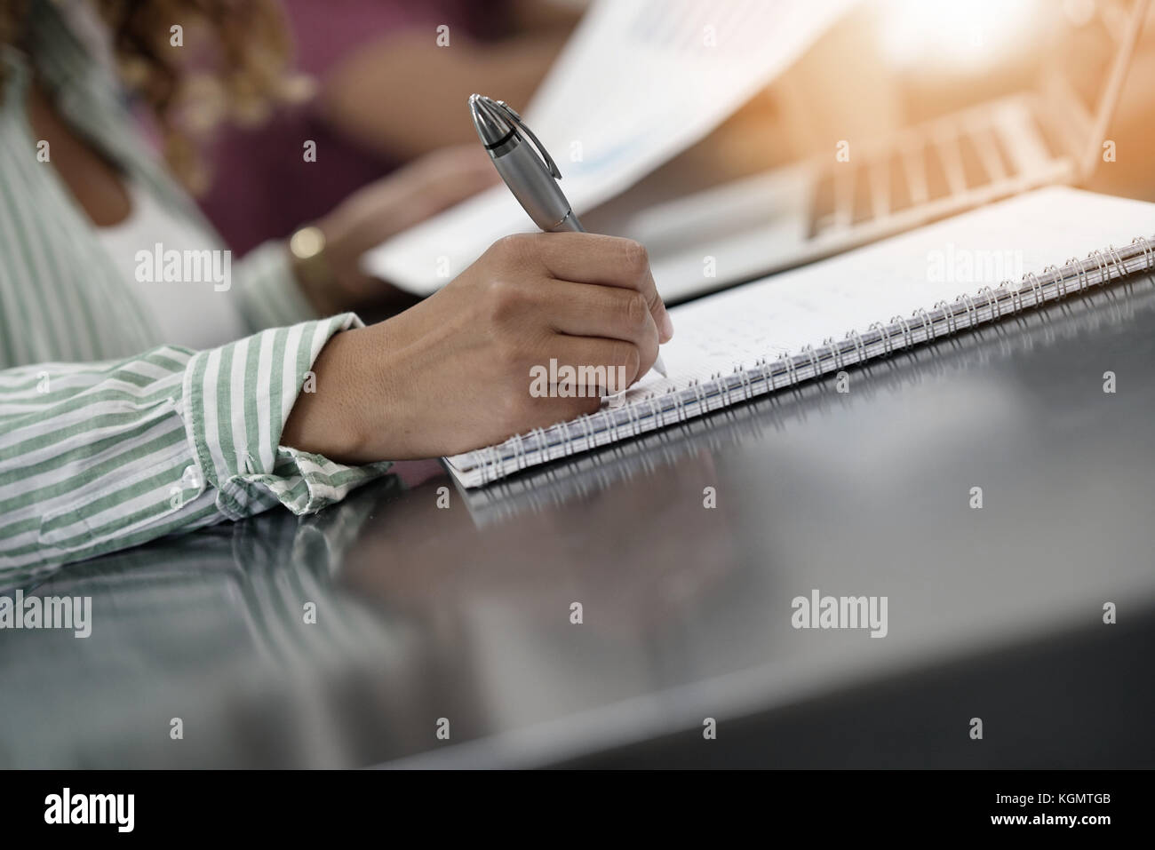 Closeup of woman's hand writing on notebook Stock Photo - Alamy