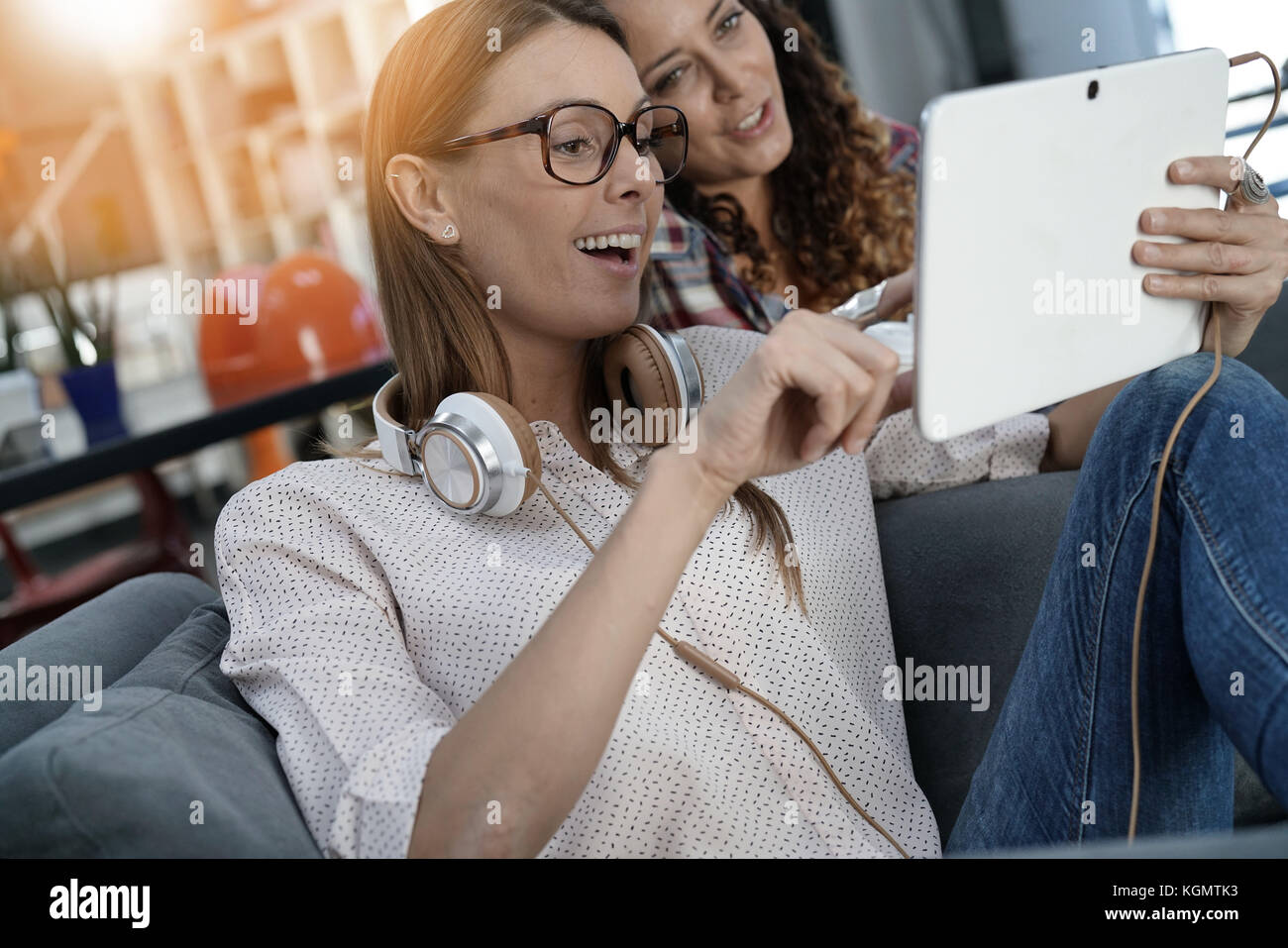 Girls having fun connected with digital tablet Stock Photo - Alamy
