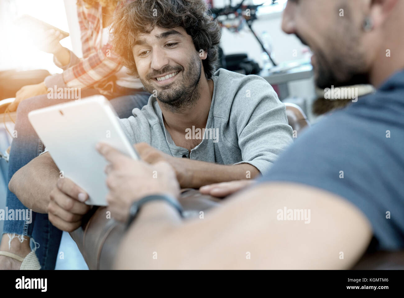 Men connected on digital tablet Stock Photo - Alamy