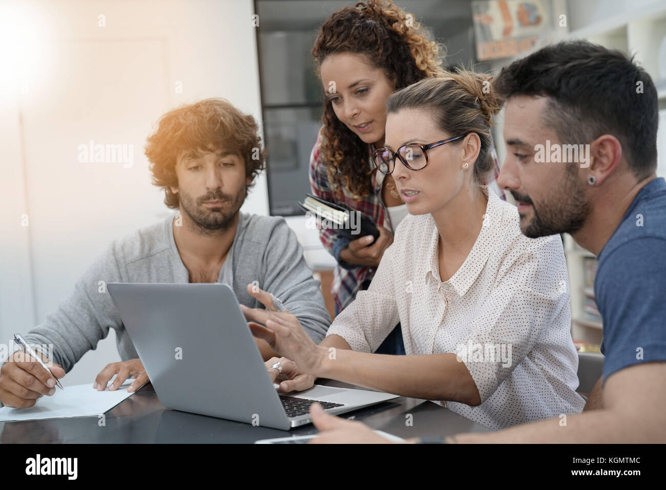 Young people meeting with laptop computer Stock Photo - Alamy