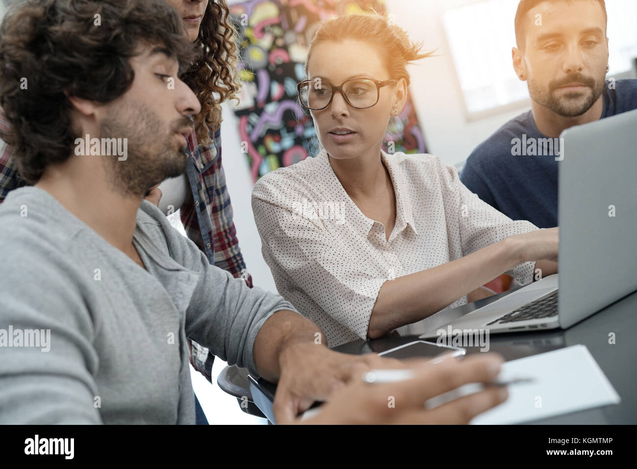 Young people meeting with laptop computer Stock Photo - Alamy