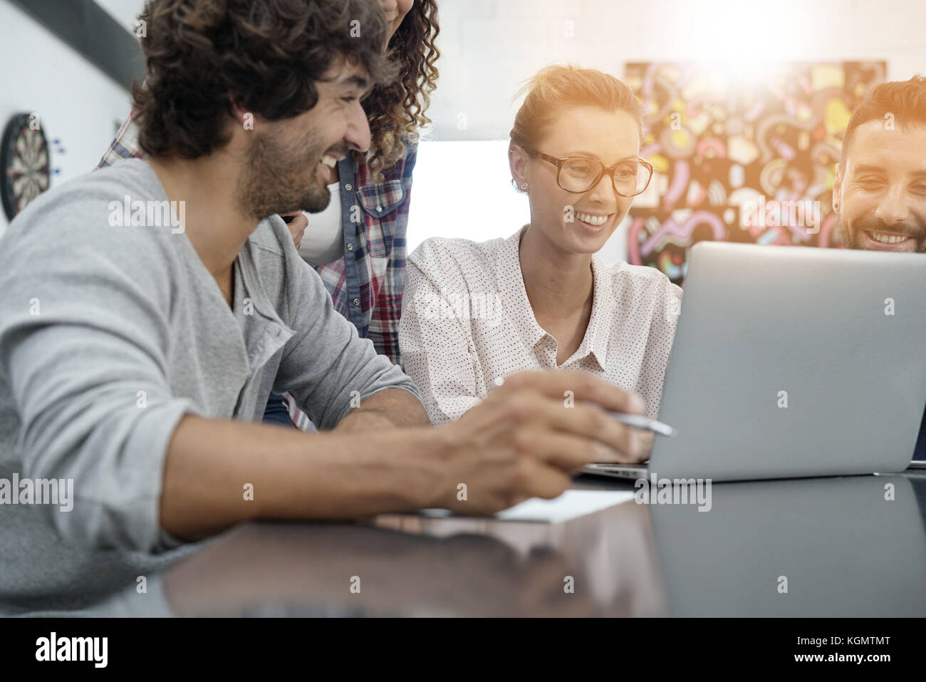 Young people meeting with laptop computer Stock Photo - Alamy