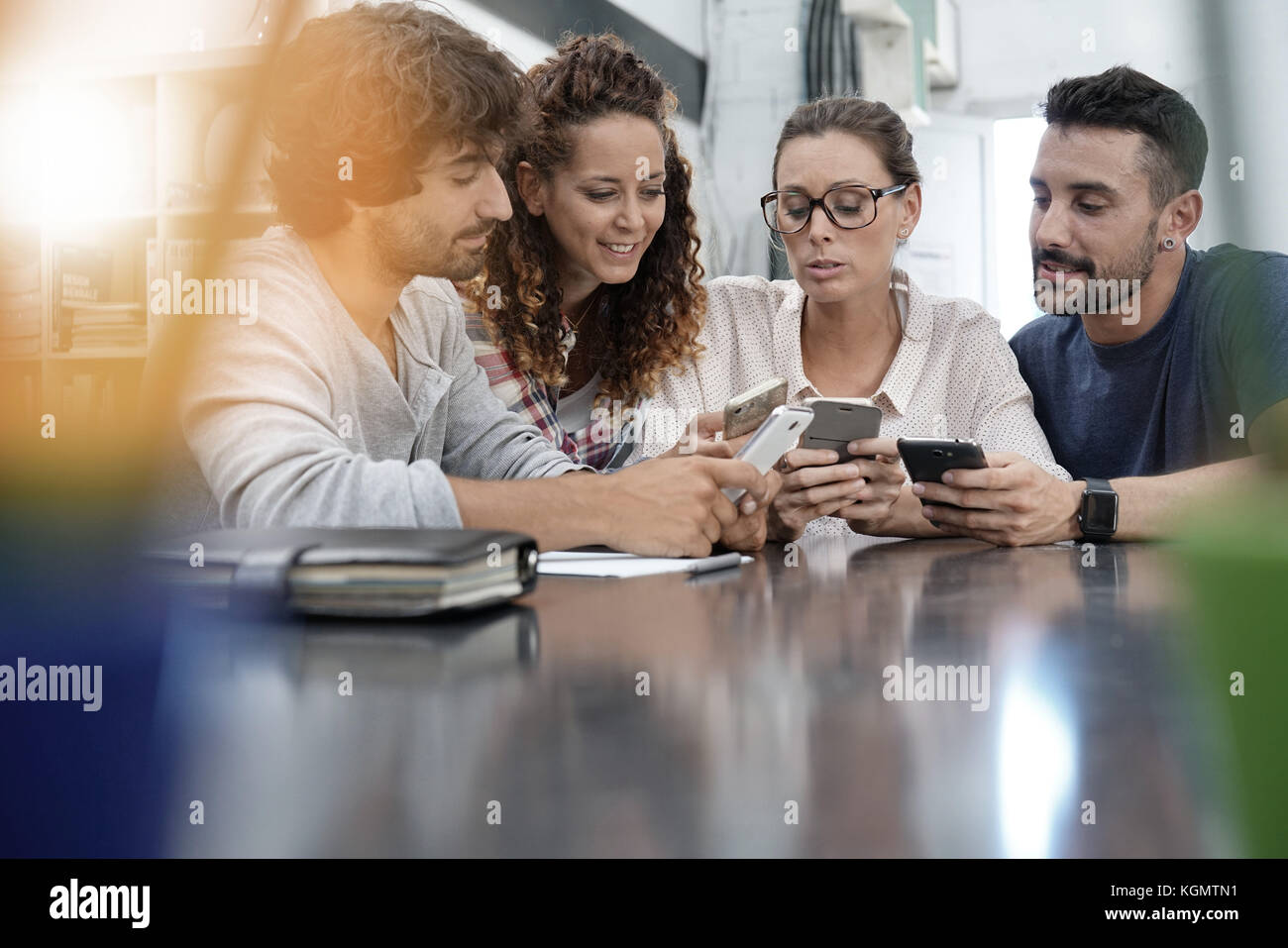 Group of young people playing with smartphones Stock Photo - Alamy