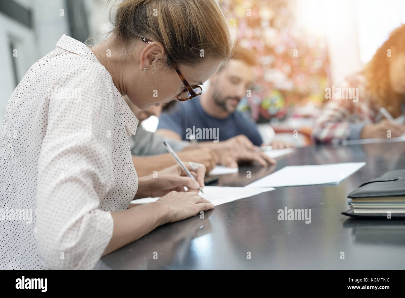 University students filling in application form Stock Photo - Alamy