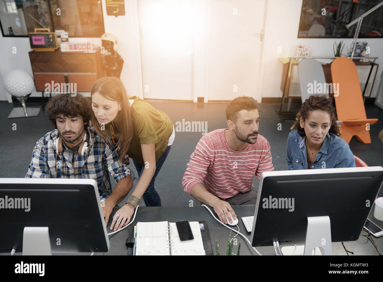 Start-up people working on desktop in co-working space Stock Photo - Alamy